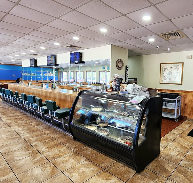 Counter seating that invites conversation with strangers who become friends over coffee refills and shared appreciation for proper diner protocol.