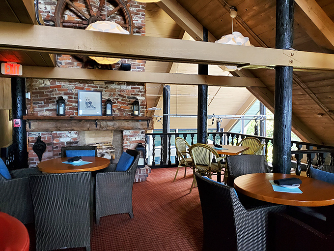 Nautical meets cozy in this upstairs nook where ship wheels and exposed beams create the perfect backdrop for seafood storytelling.