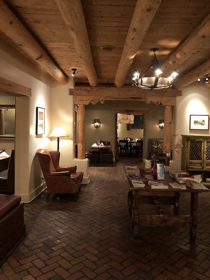 The warm glow of wooden vigas and brick floors welcomes you like an old friend. This isn't just a waiting area&mdash;it's the prelude to a memorable meal.