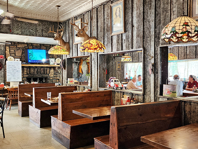 Step inside and you're transported to a simpler time &ndash; deer head lamps illuminate church pew booths while the pressed tin ceiling whispers stories of meals past. 