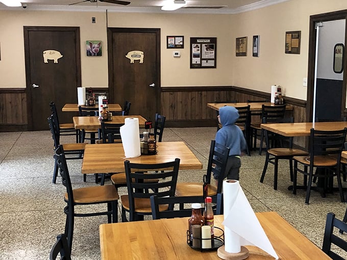 Pig silhouettes mark the restroom doors—a whimsical reminder that you're in a place that takes pork seriously but itself less so.