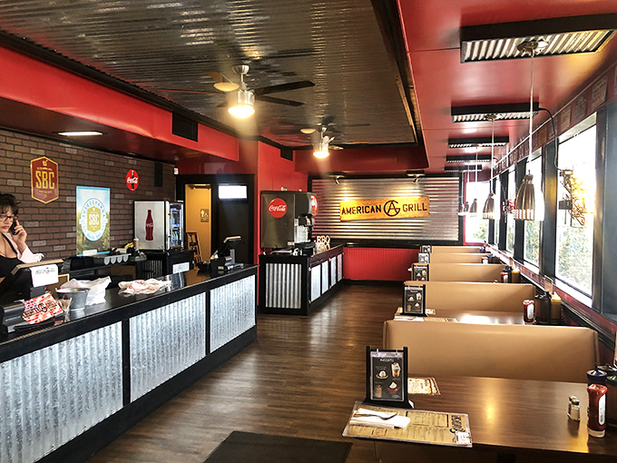 Step inside where red walls and booth seating create the perfect backdrop for serious barbecue business.