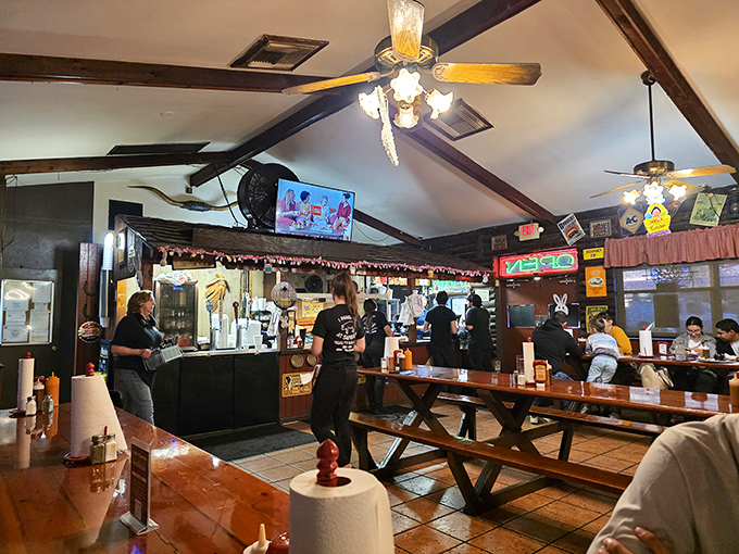 Inside, wooden beams and picnic tables tell you everything: this isn't dinner theater, folks&mdash;it's a temple of smoke where napkins aren't optional, they're essential equipment.