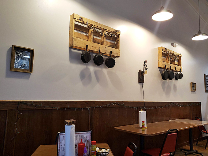 Cast iron skillets hang like trophies on rustic wooden pallets, silent witnesses to countless perfect breakfasts. They've seen things, delicious things.