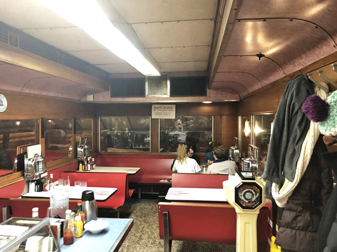 Inside Mickey's, red vinyl booths cradle conversations between strangers and old friends alike, while the curved ceiling creates a cocoon of comfort and nostalgia.