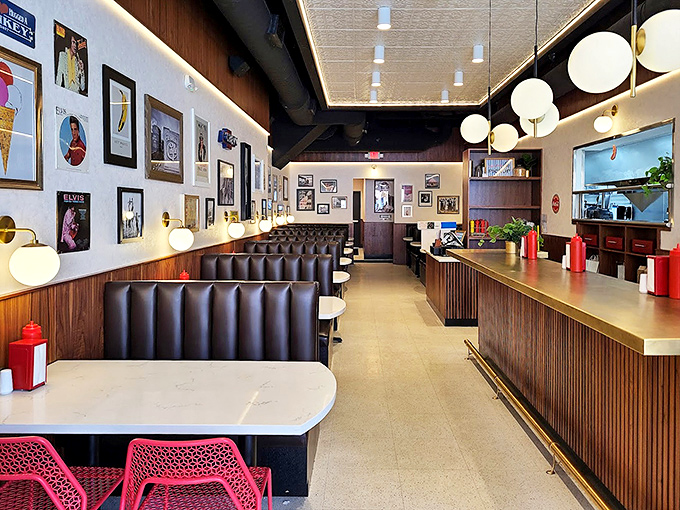 Sleek booths, globe lighting, and art-adorned walls create a modern diner vibe where comfort meets cool&mdash;the perfect backdrop for burger epiphanies.