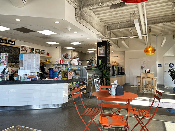 Inside, white-tiled counters and vibrant orange chairs create the perfect backdrop for serious sandwich contemplation and coffee sipping.