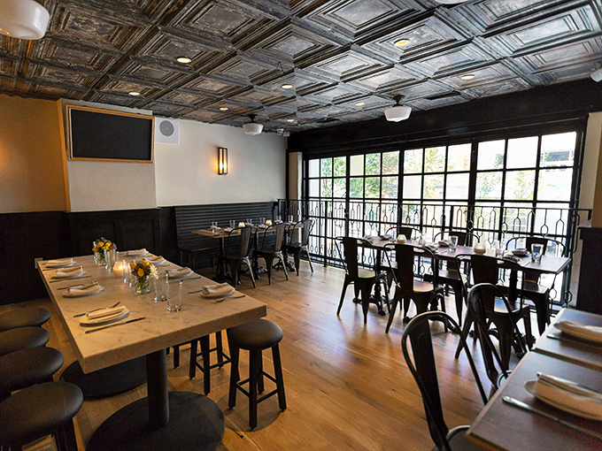 Pressed tin ceilings, warm wood tables, and industrial-chic metal chairs create the perfect backdrop for the meat-centric masterpieces about to arrive.