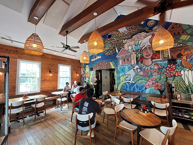 Step inside to discover wooden warmth meets artistic flair&mdash;that mural isn't just decoration, it's a conversation starter that'll keep you lingering long after your meal. 