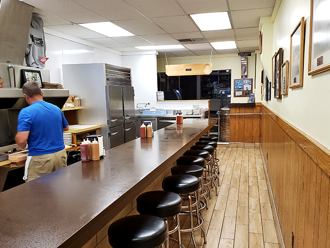 A counter that tells stories&mdash;where generations have spun on these stools, waiting for burger perfection that's worth every minute. 