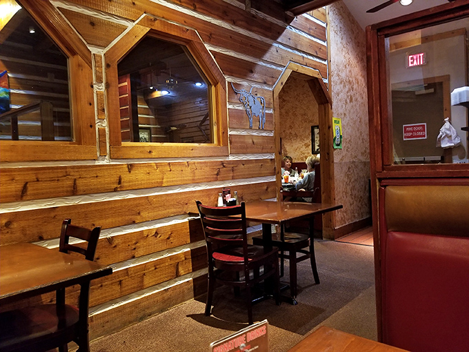 Rustic log cabin walls and octagonal windows create intimate dining nooks where conversations flow as freely as the drinks. Comfort never looked so inviting.