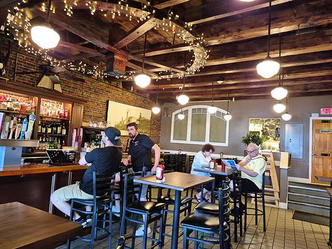 Exposed brick walls, wooden beams, and twinkling lights create the perfect atmosphere for seafood indulgence without pretension.