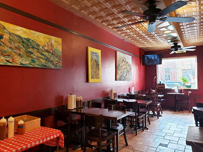 The warm red walls and ornate tin ceiling create that perfect "come as you are, leave as family" vibe that every great BBQ joint needs.