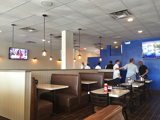 Fort Lauderdale's breakfast faithful gather beneath pendant lights and blue accent walls, where morning conversations flow as freely as the coffee.