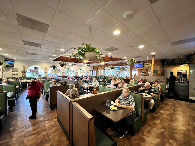Inside, the classic diner booths tell stories of countless conversations, while hanging plants add a touch of homey charm that HGTV could never replicate. 