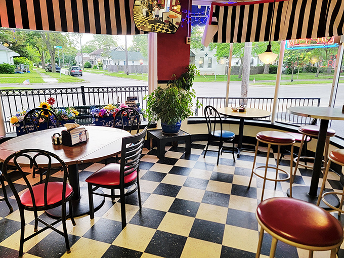 Classic black and white checkered floors meet cozy red vinyl seating in this time capsule of American diner culture, where every table feels like the best seat in the house.