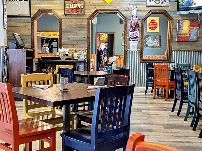 Colorful chairs and rustic wood paneling create that perfect "come as you are, leave fuller than you arrived" atmosphere that defines great barbecue joints.