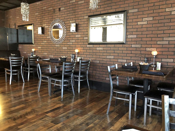 Exposed brick walls and warm wooden floors create the perfect backdrop for the culinary drama about to unfold at your table.