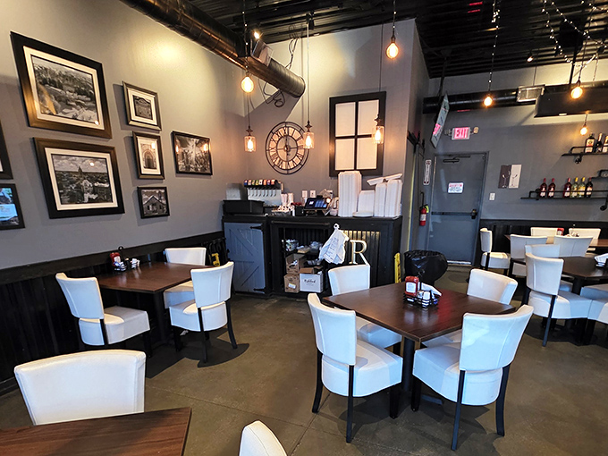 Modern meets cozy in this thoughtfully designed dining room. The pendant lighting and local photography create an atmosphere that says, "Stay awhile, the food's worth it."