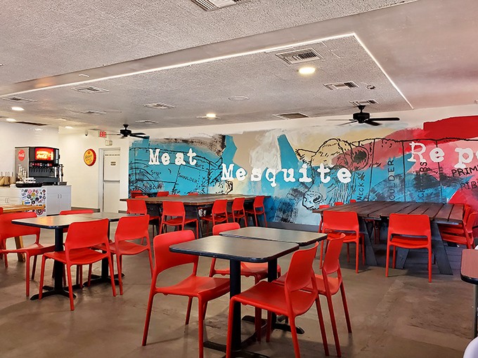 Inside, vibrant red chairs pop against the "Meat Mesquite" mural &ndash; a colorful manifesto that tells you exactly what matters in this temple of smoke.