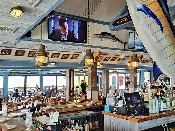 Nautical meets comfortable at Lorelei's interior bar, where ship lanterns cast a golden glow and mounted fish keep silent watch over happy patrons.