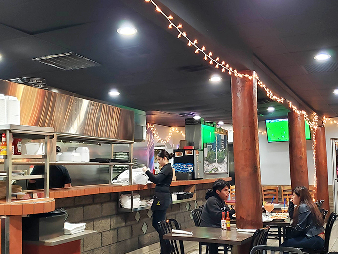 Inside, string lights and wooden pillars create that perfect "abuela's kitchen meets neighborhood gathering spot" vibe that makes everyone feel at home.
