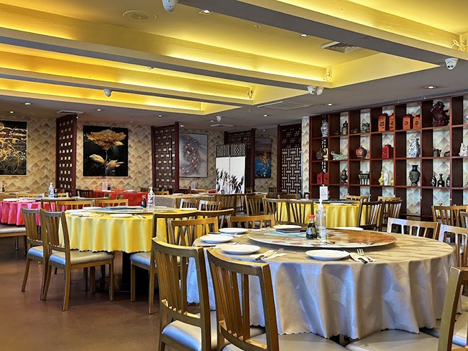 The dining room's golden glow and round tables set the stage for family-style feasting&mdash;where the real stars aren't the decorations but what's about to land on those pristine tablecloths.