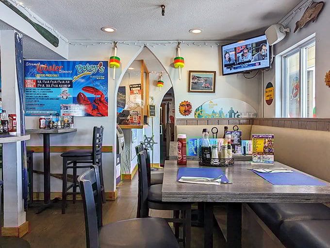 Nautical meets cozy in this dining area where fishing buoys hang from the ceiling and ocean-themed decor sets the perfect maritime mood.