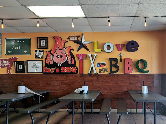 Texas pride explodes across the walls with colorful declarations of barbecue devotion. That flaming pig mascot knows exactly what you're in for.
