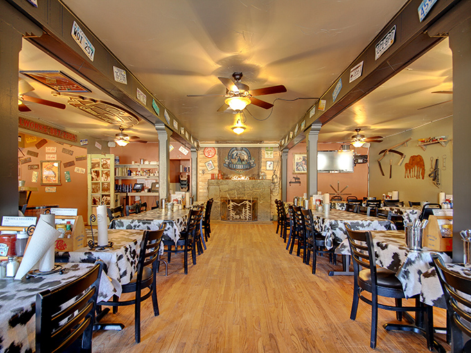 Step inside to a Western wonderland where cowhide-patterned tablecloths and rustic decor create the perfect backdrop for serious barbecue business.