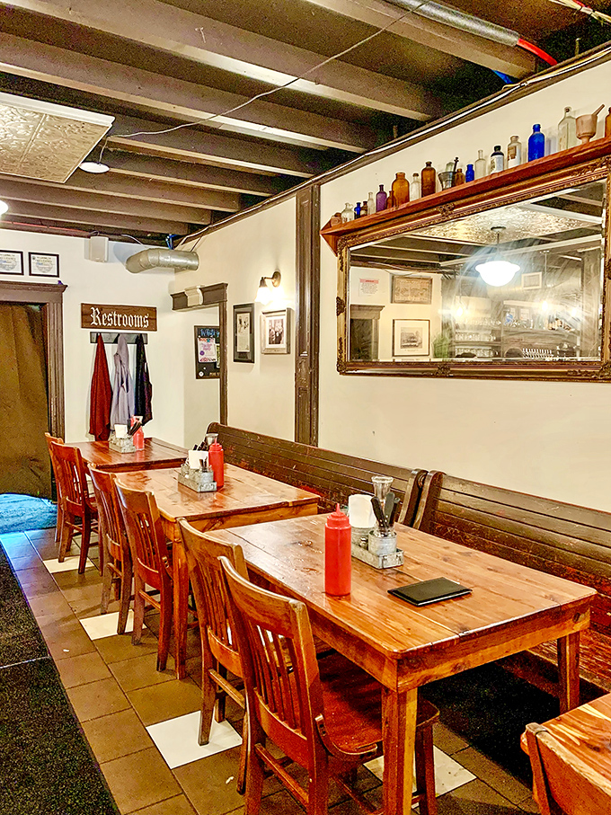 Wooden tables, vintage mirrors, and antique pharmacy bottles create an atmosphere that's part German beer hall, part time machine to simpler days.
