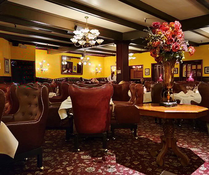 Leather chairs you could disappear into for days, golden walls, and floral arrangements that would make your mother-in-law jealous.