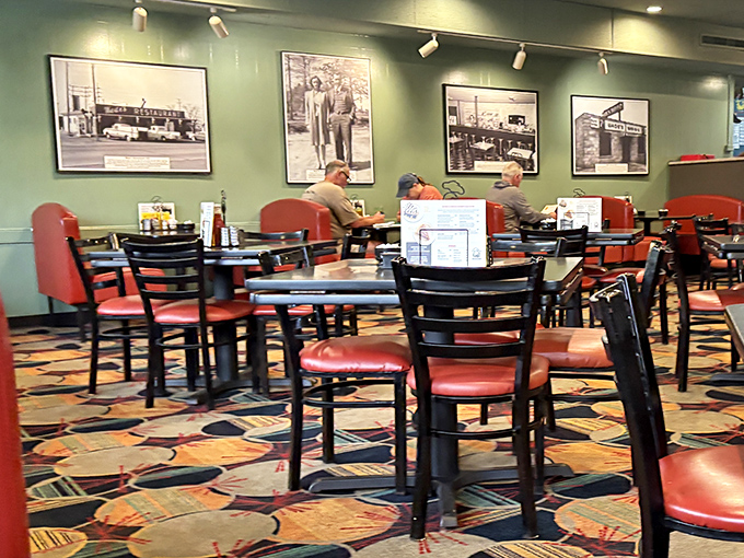 The dining room whispers stories through vintage photographs while red vinyl chairs promise comfort for the feast ahead.