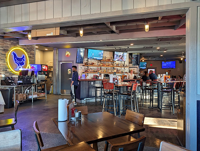 The neon chicken sign illuminates the bar like a poultry-themed bat signal, summoning fried chicken enthusiasts from miles around.