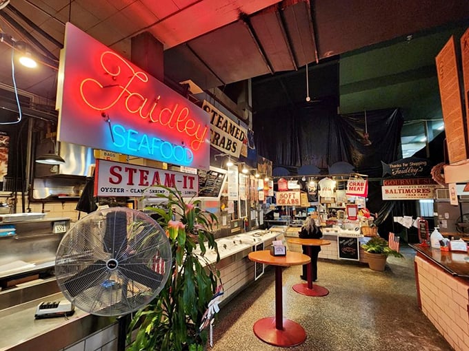 Inside this bustling marketplace, neon signs glow like beacons guiding you to crab cake paradise.