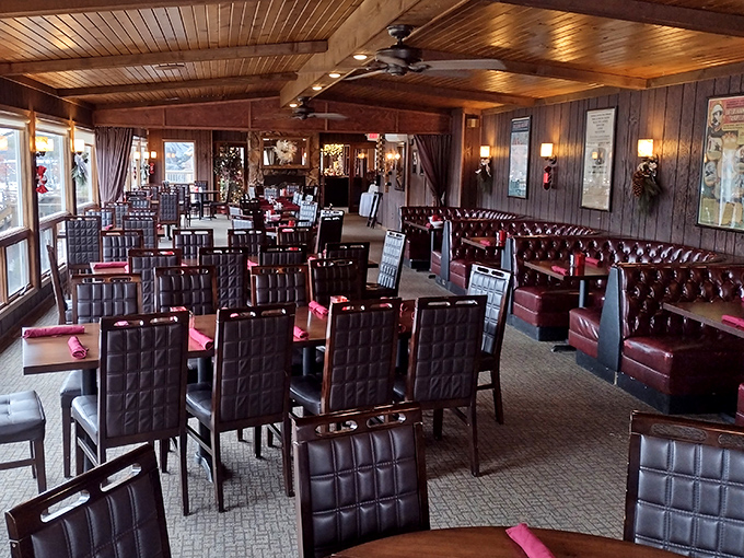 Wood-paneled perfection meets burgundy leather in a dining room that feels like a warm embrace.