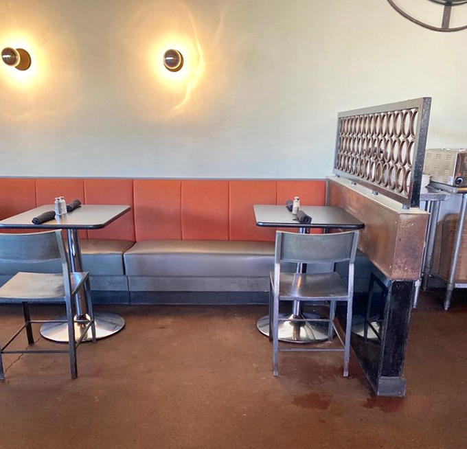 Those coral booths could've been lifted from a Mad Men set, minus the three-martini lunches.