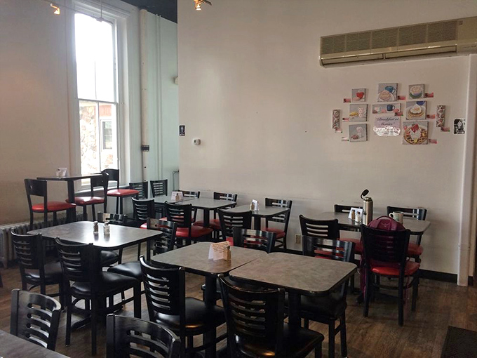 Simple, clean, and inviting&mdash;this dining room doesn't need fancy frills when the food does all the talking. Those red chairs are about to cradle some happy diners.
