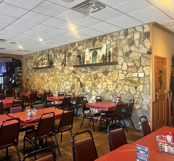 That gorgeous stone wall creates the perfect backdrop for conversations that flow as freely as the drinks.