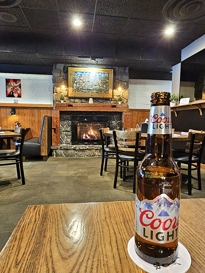 Stone fireplace, warm lighting, and that Coors Light knows exactly where it belongs in this cozy scene.