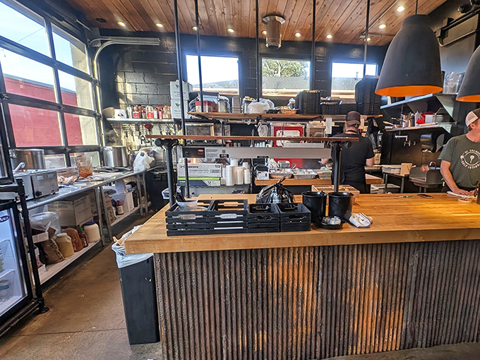 Behind the counter magic: Corrugated metal, wooden accents, and the organized chaos of a serious barbecue operation.