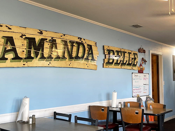 Weathered wooden signs tell tales of maritime heritage against soothing blue walls &ndash; this isn't designer decor, it's authentic coastal character that money can't buy.