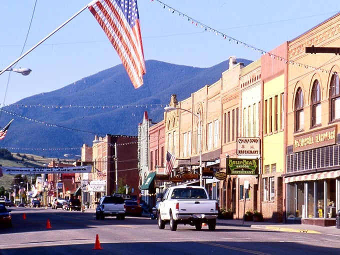 American flags flutter above historic storefronts that haven't changed their tune in a century. Norman Rockwell would've needed extra paint.