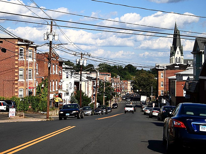 Residential streets climb gentle hills, where church spires punctuate the skyline like exclamation points in New Britain's architectural story.