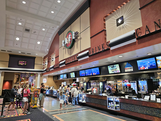 The Grand 14 Cinema lobby isn't just selling popcorn; it's selling the increasingly rare luxury of forgetting the world for two hours.