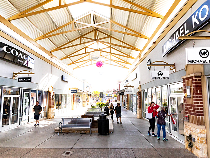 The architectural trifecta: Coach on the left, Michael Kors on the right, and the promise of retail therapy straight ahead under those gorgeous wooden beam ceilings.