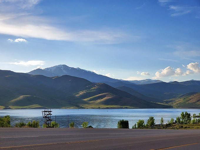 Nature's touch transforms Deer Creek's shoreline into a painter's palette, with Mount Timpanogos standing guard in magnificent splendor.