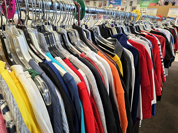 A rainbow of possibilities hangs in perfect formation. Each shirt represents someone's past and awaits its starring role in another's future.