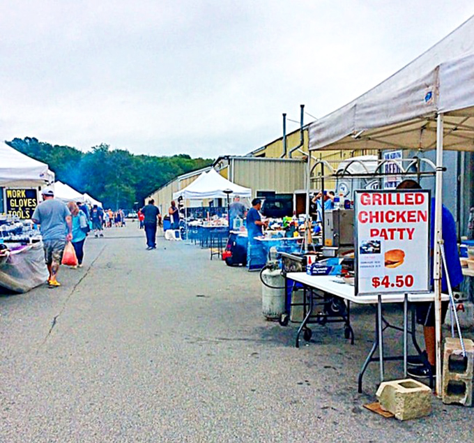 Outdoor vendors create a maze of possibilities under New England skies. The grilled chicken patty sign promises sustenance for serious shoppers.