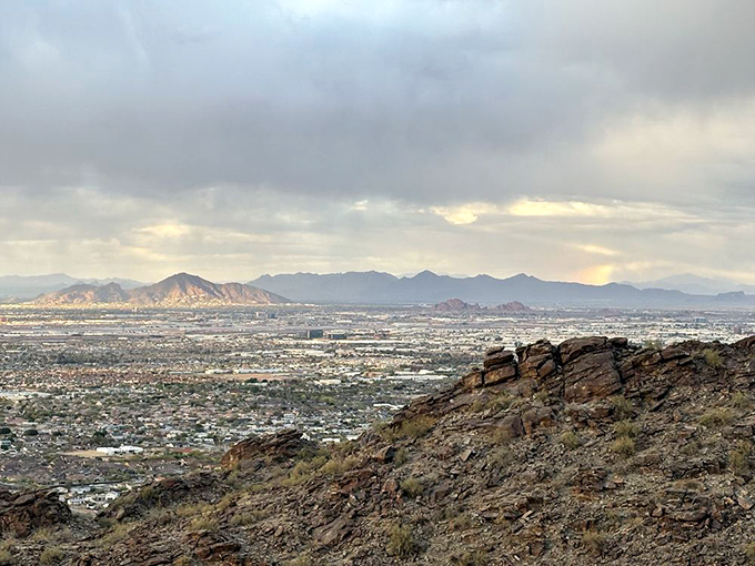 Mother Nature's own IMAX experience &ndash; Phoenix unfolds beneath moody skies, with distant mountains standing like silent guardians of the valley.